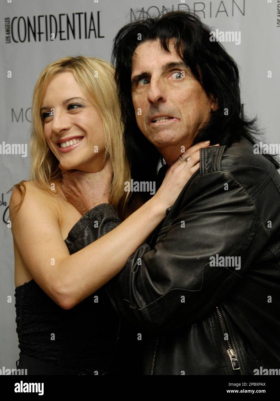 Rock singer Alice Cooper poses with his daughter Calico before a party ...