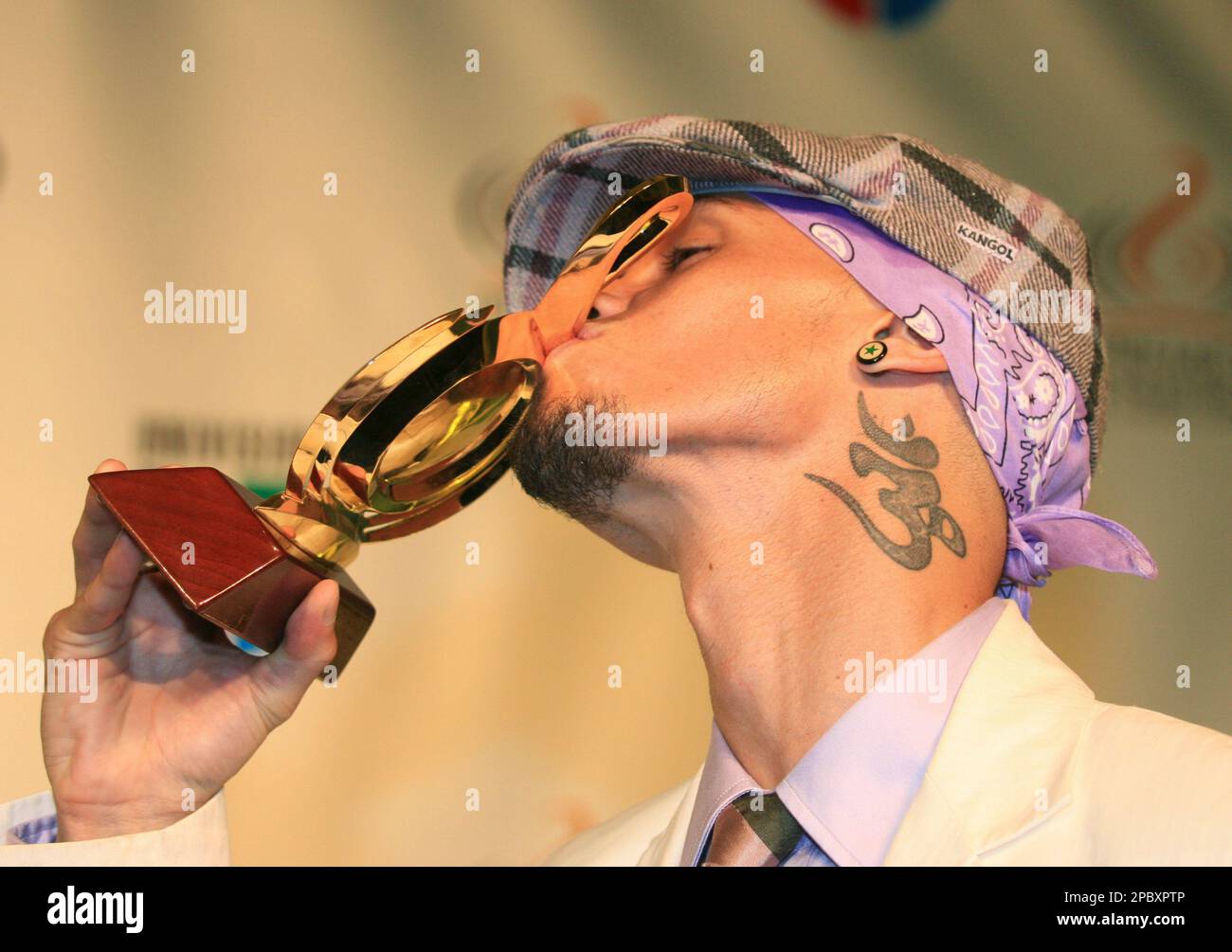 Puerto Rican singer Chelo kisses his award as he poses backstage at ...