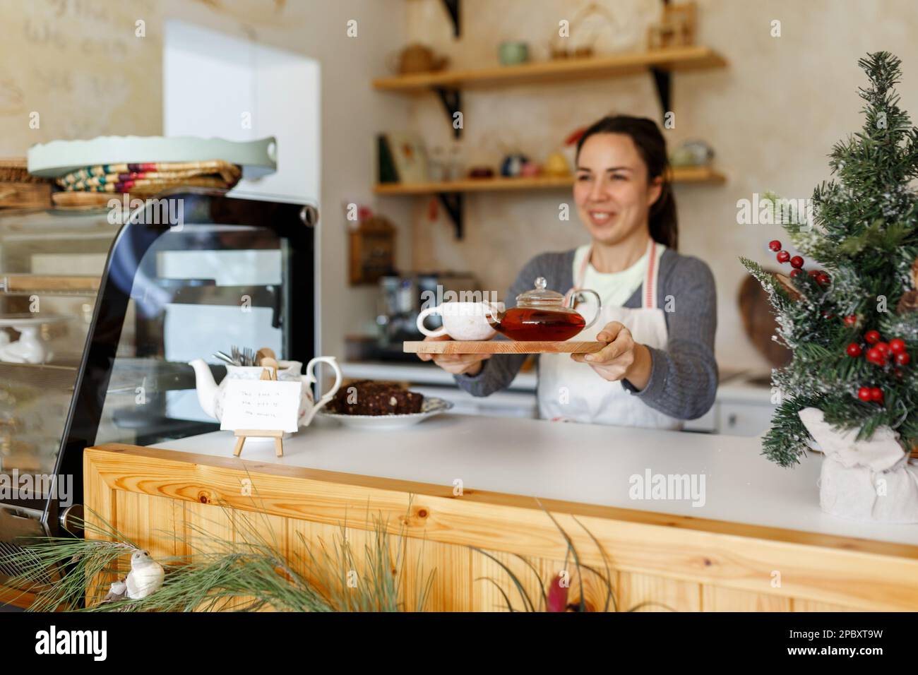 Happy young woman in apron, startup come true. Small business concept ...