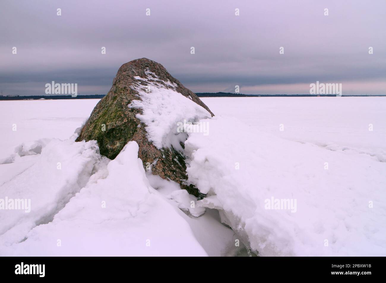 winter landscape with granite rock and cracked ice Stock Photo - Alamy