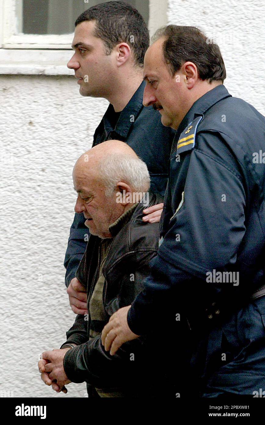 Montenegrin police officers escort Smail Tulja, 67, to a court ...