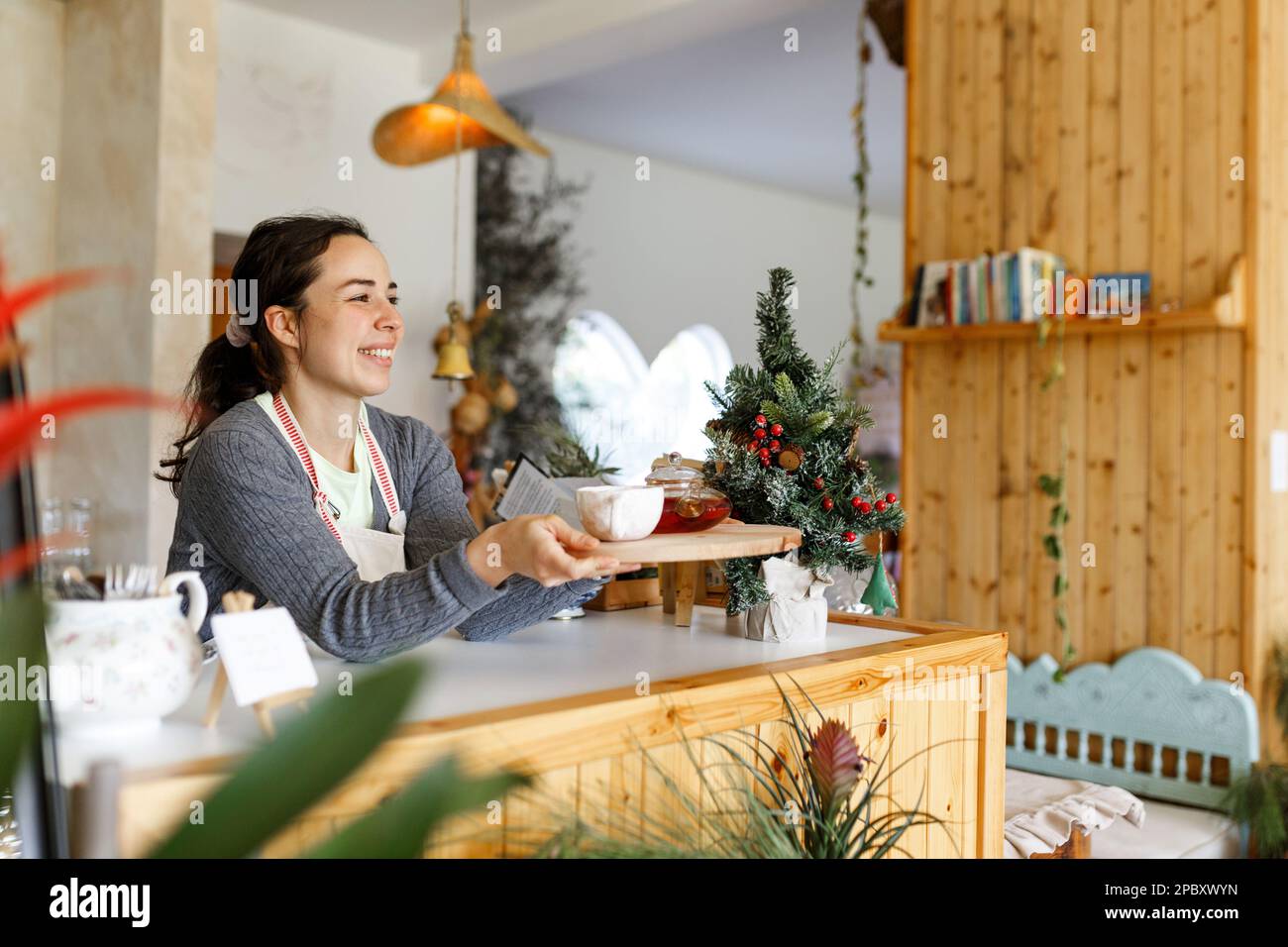 Happy young woman in apron, startup come true. Small business concept ...
