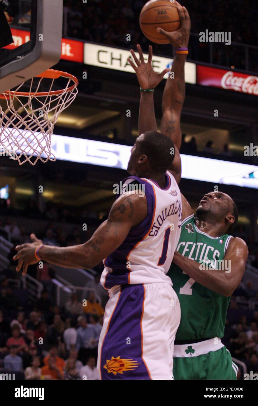 Phoenix Suns' Amare Stoudemire, left, is fouled by Boston Celtics' Ryan ...