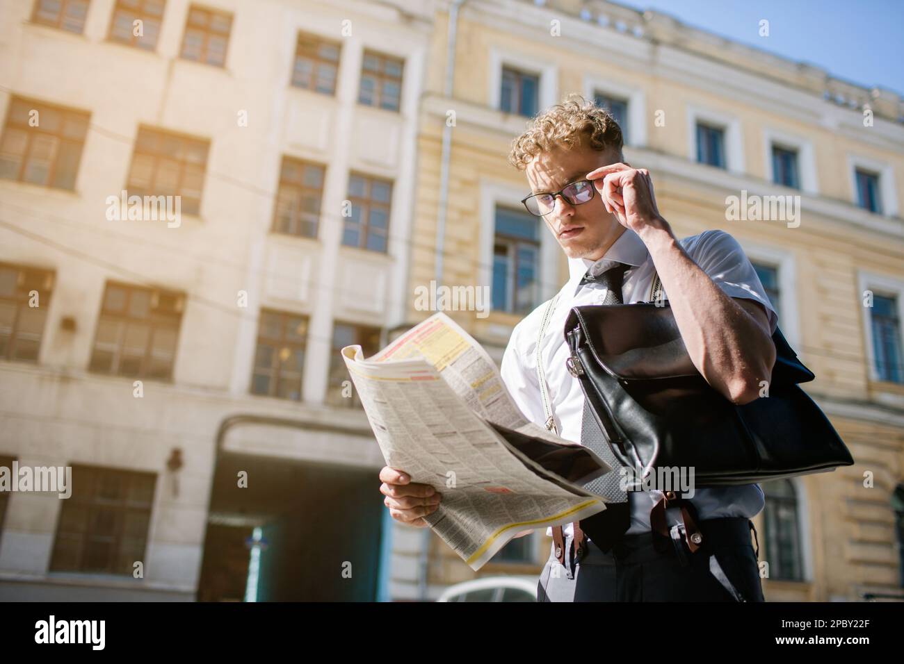 information news confused man reading newspaper Stock Photo - Alamy