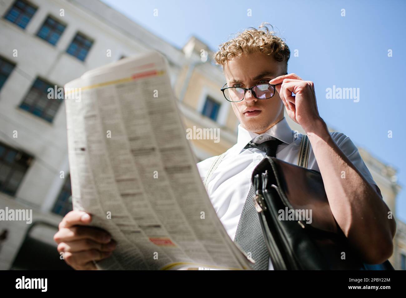 surprising shocking news media man reading paper Stock Photo - Alamy