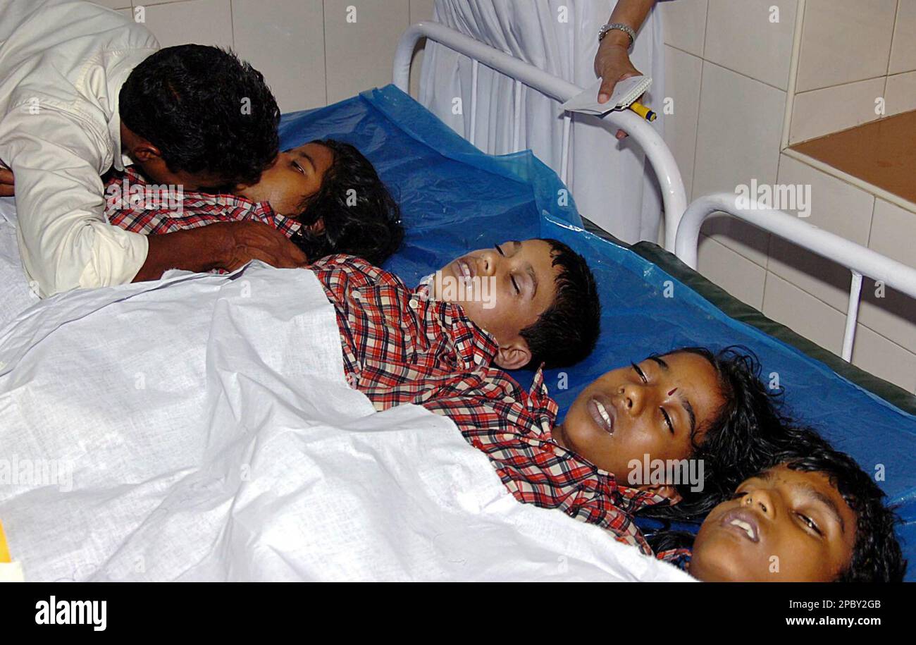 An unidentified person breaks down after seeing the bodies of children ...