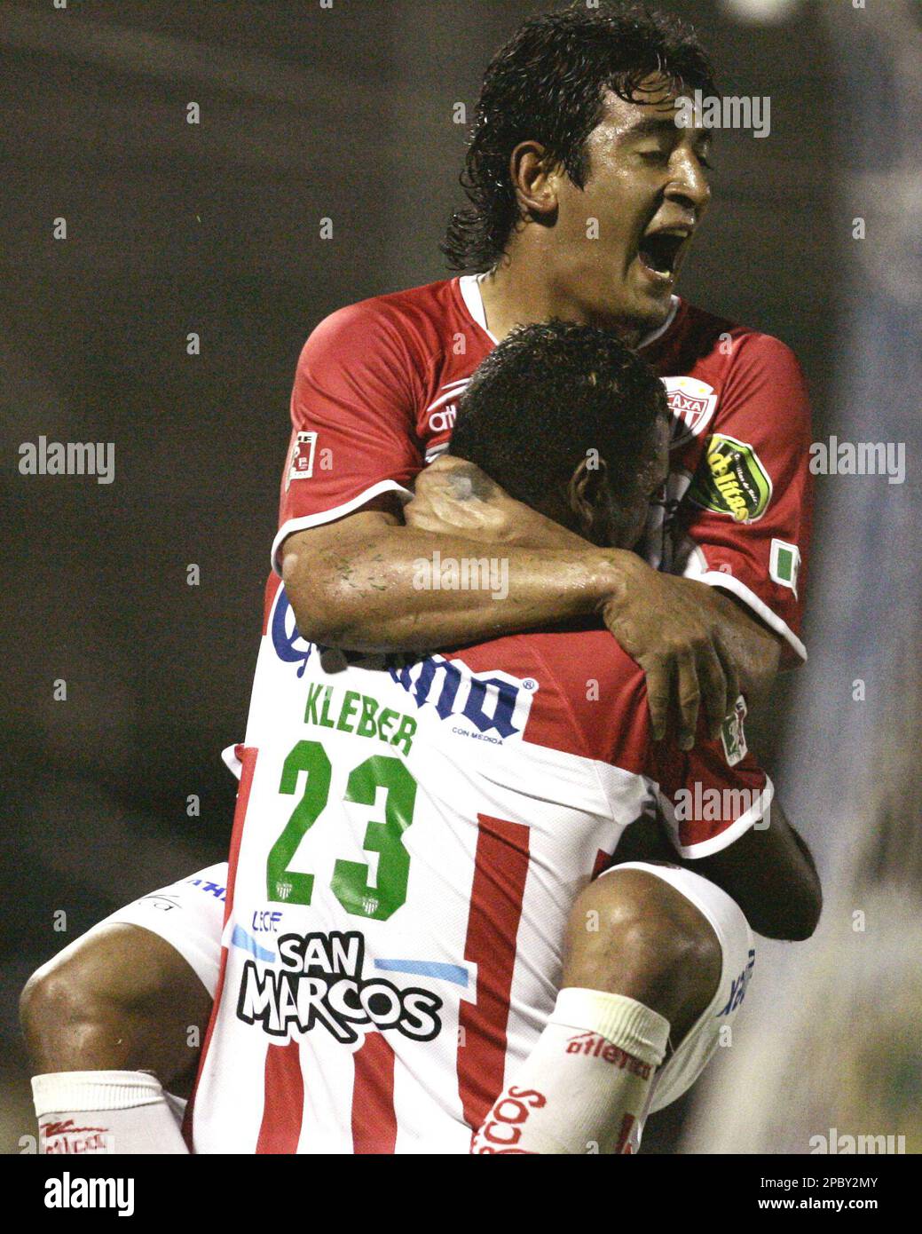 Alfredo Moreno, up, of Mexico's Necaxa celebrates with his teammate ...