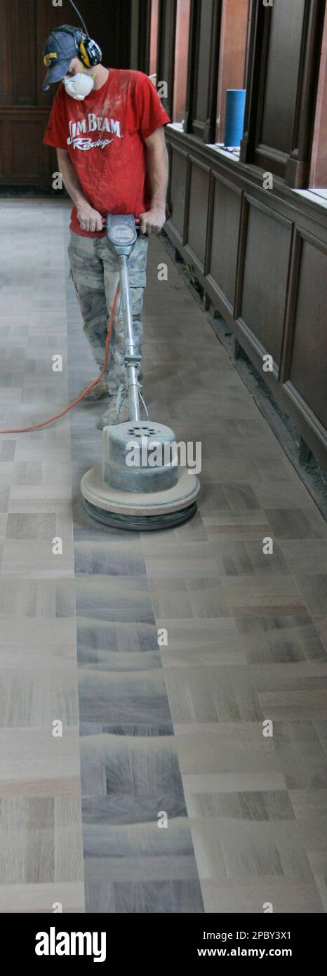 **ADVANCE FOR MONDAY, FEB. 26** Dwayne Moore sands the floor in the ...