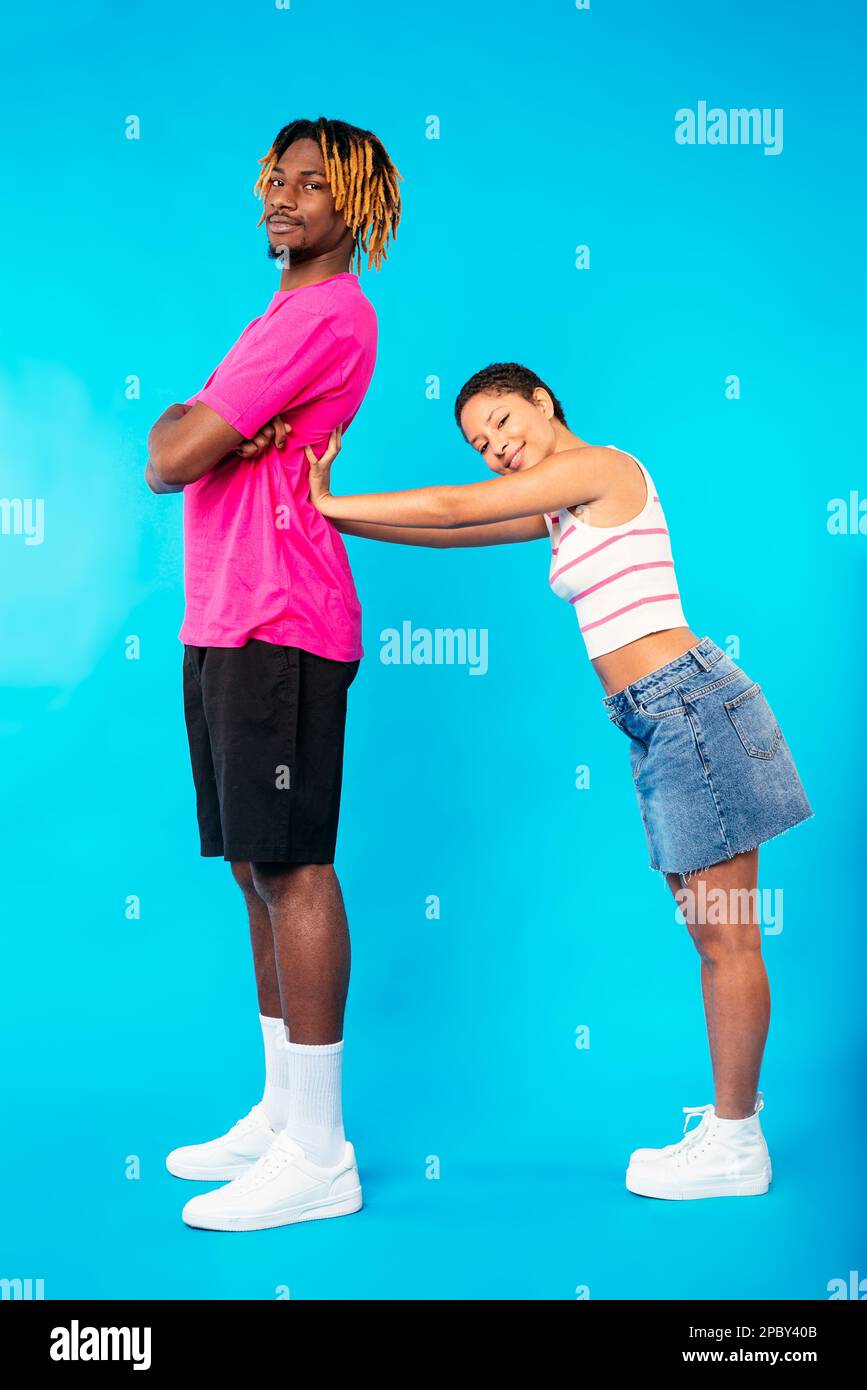 Side view of positive young ethnic female with short dark hair in ...