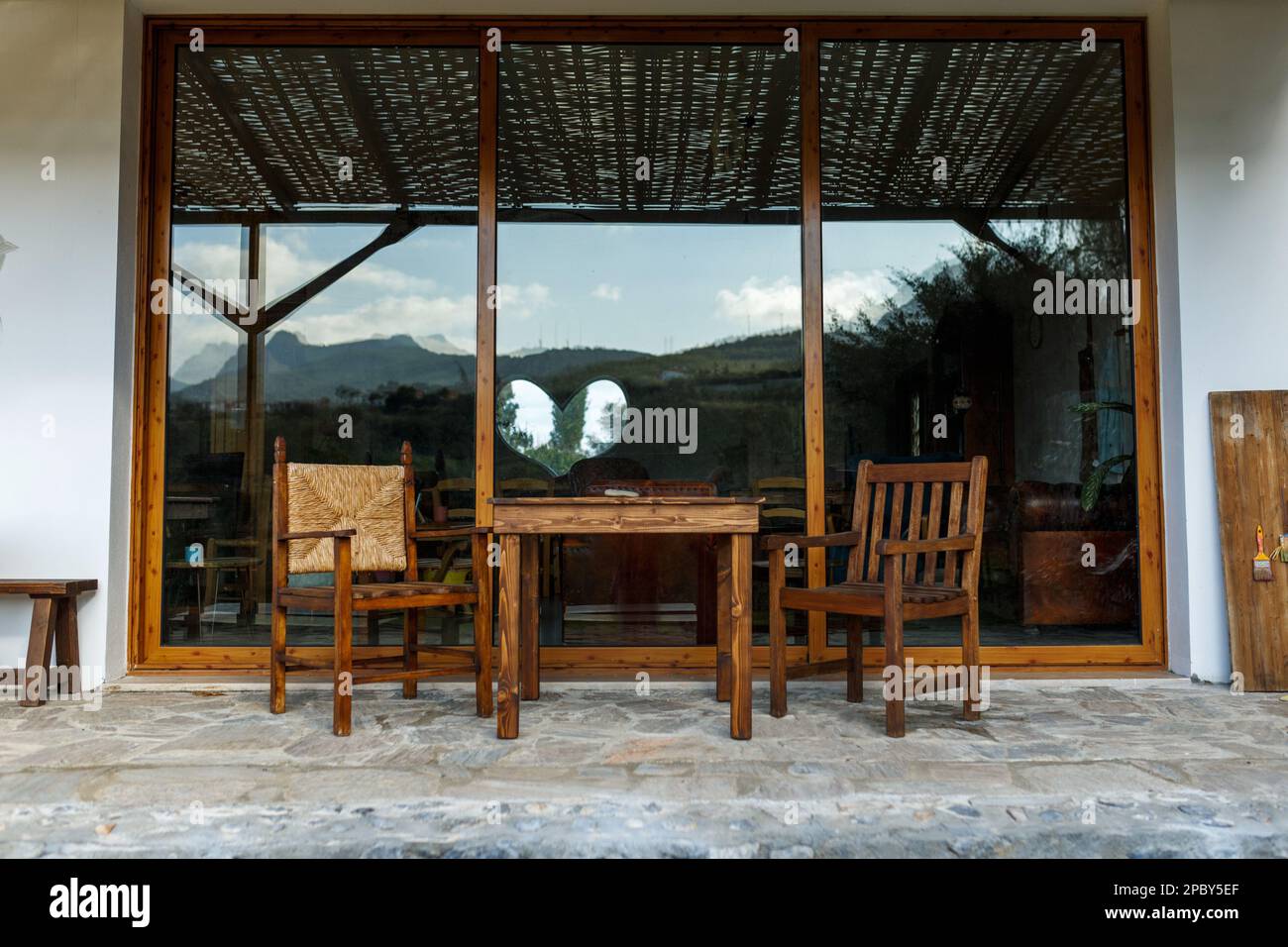 Village veranda or porchway in Cyprus. Wooden table and chairs ...