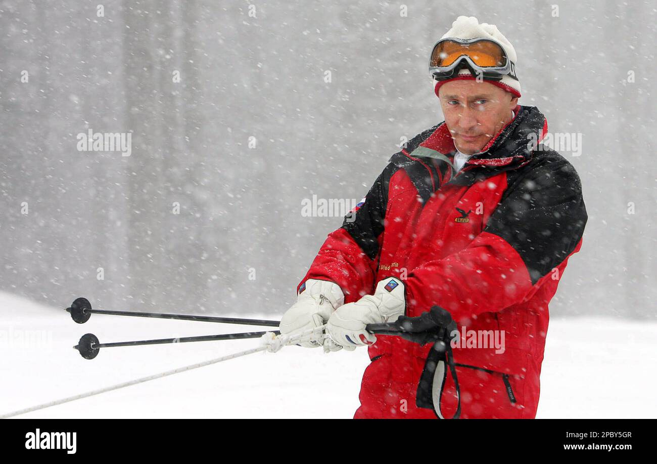 Russian President Vladimir Putin is pulled by a snowmobile in the ...