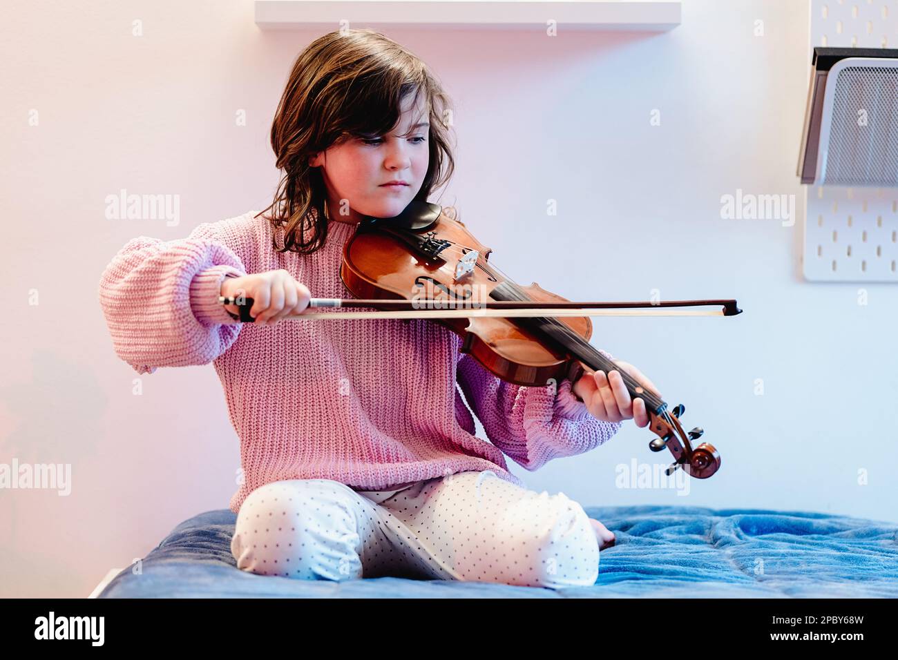 Full body of adorable talented little girl with brown hair in casual ...