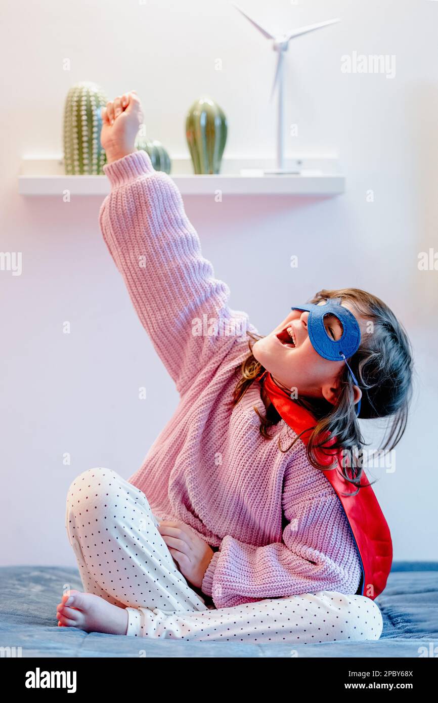 Full body of adorable little girl with dark hair in warm sweater ...