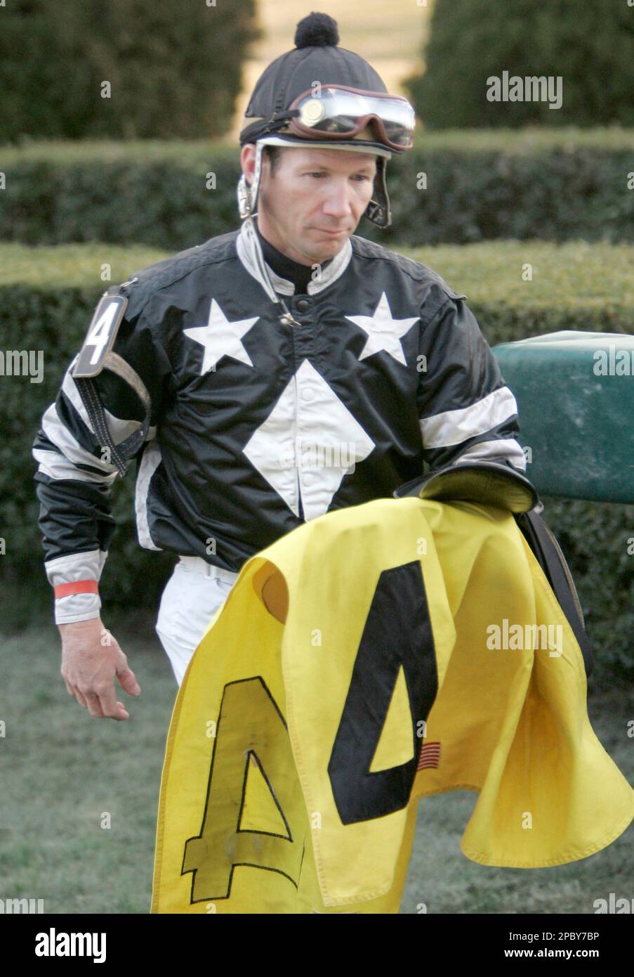 Jockey Stewart Elliott carries his saddle from the winners circle after ...
