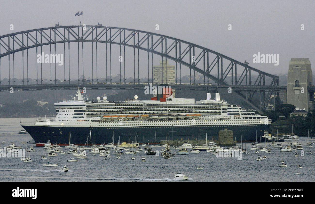 The Queen Mary 2 arrives in Sydney Harbor at sunrise surrounded by a ...