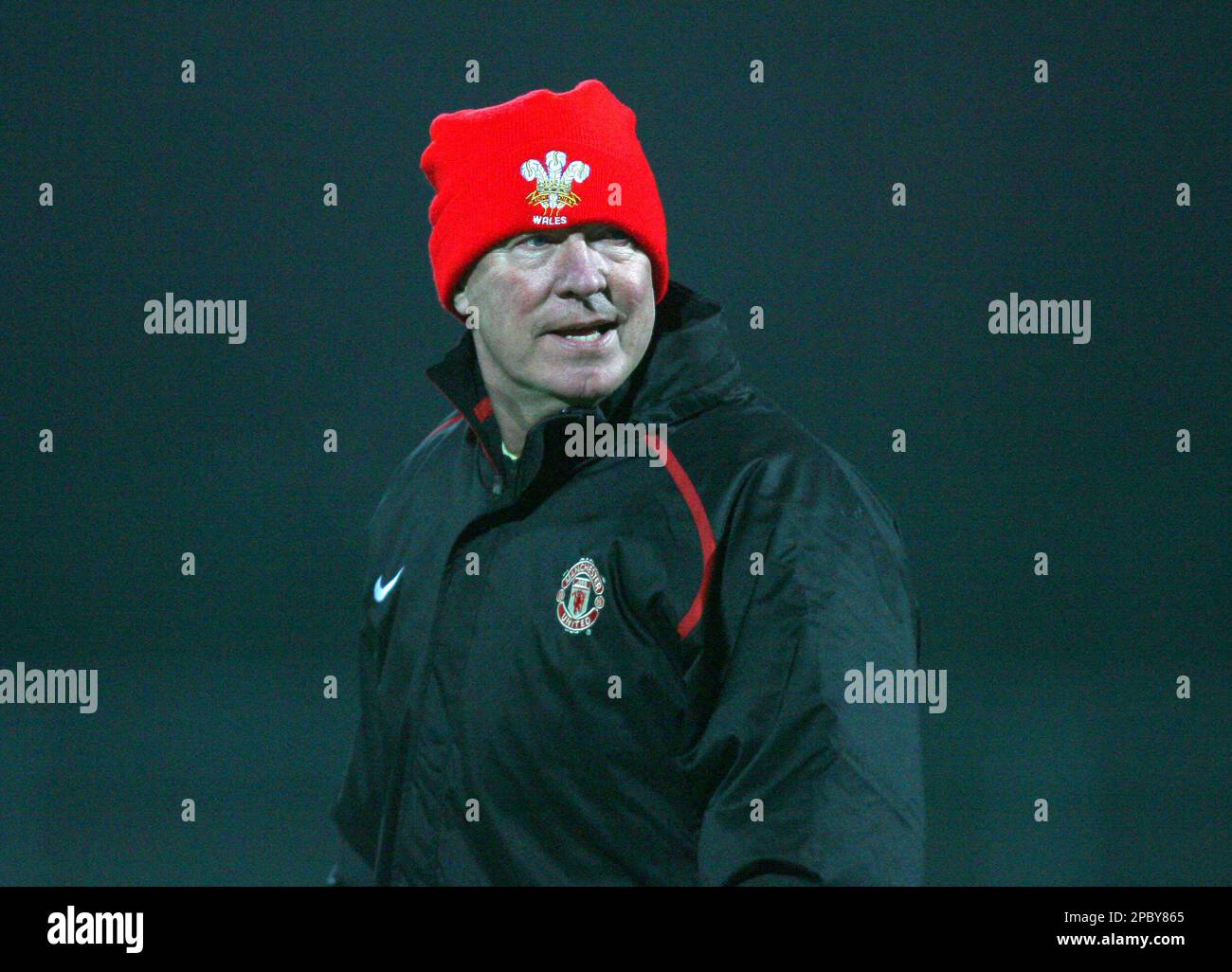 Manchester's United's manager Sir Alex Ferguson wears a hat with a ...