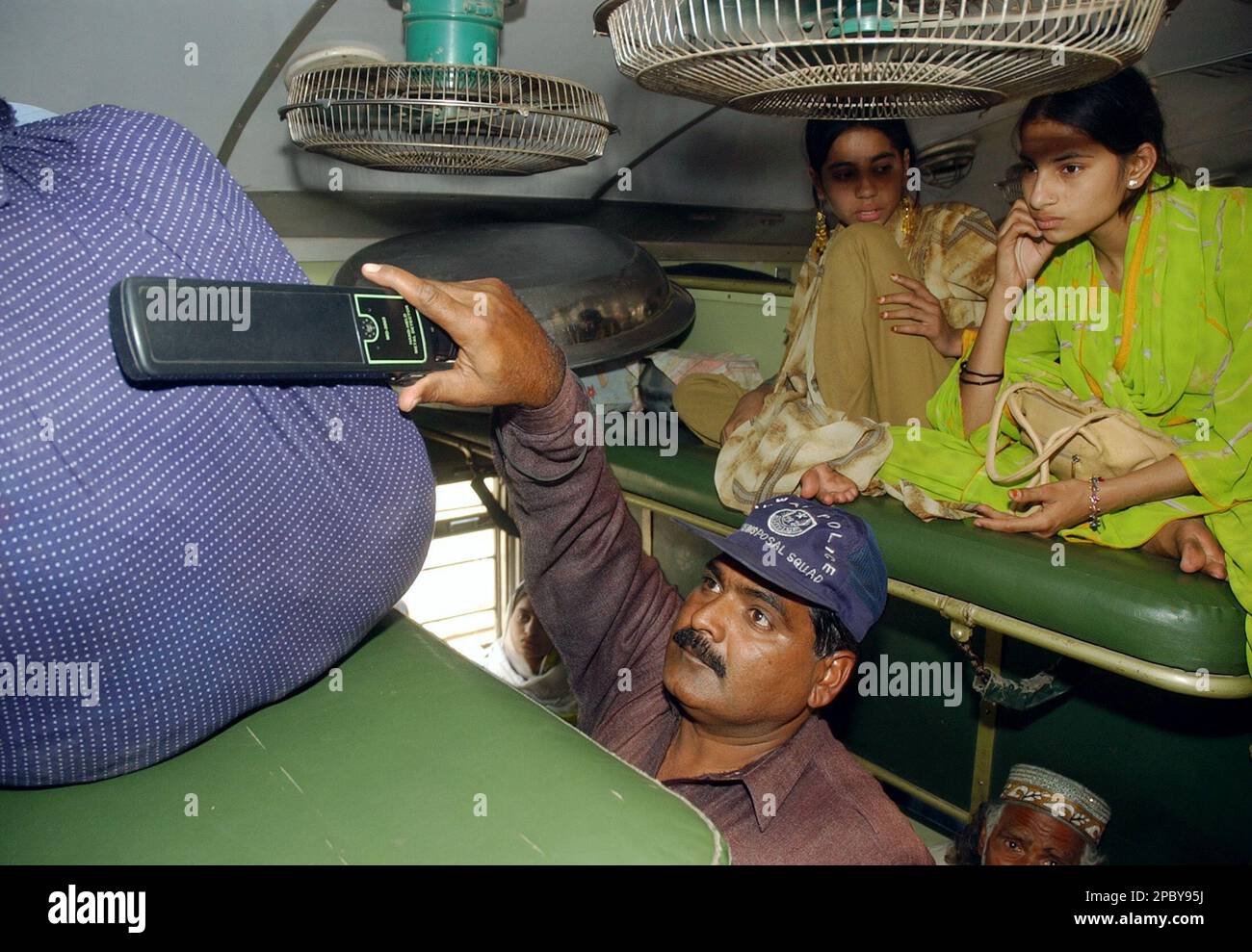 A Pakistan's railway police officers checks a luggage of passengers at ...