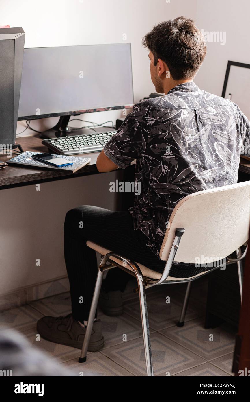 Back view of black man sitting at table hi-res stock photography and ...