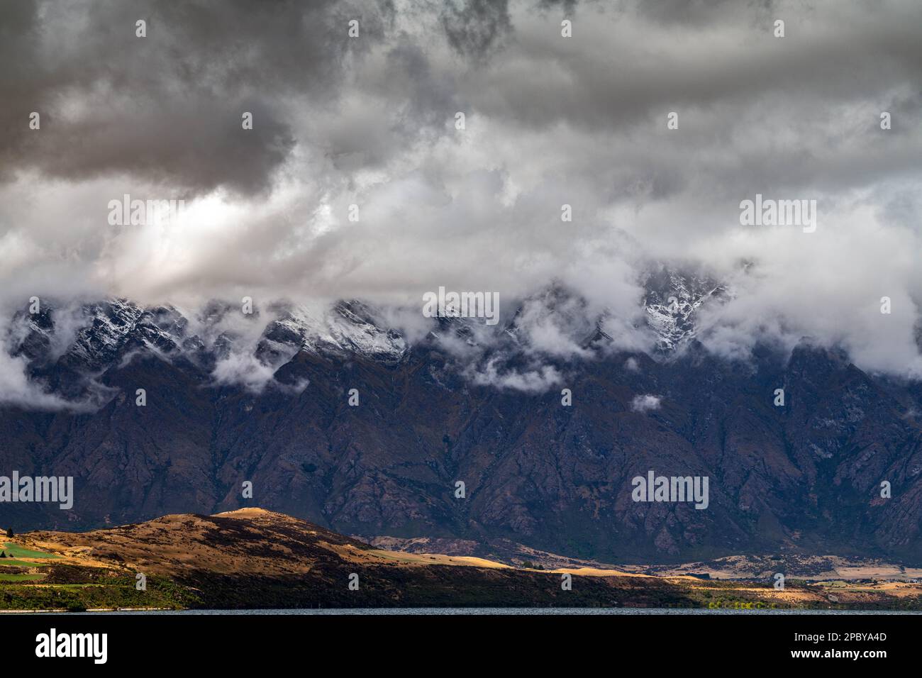 Early season snow is seen falling on the peaks of The Remarkables ...