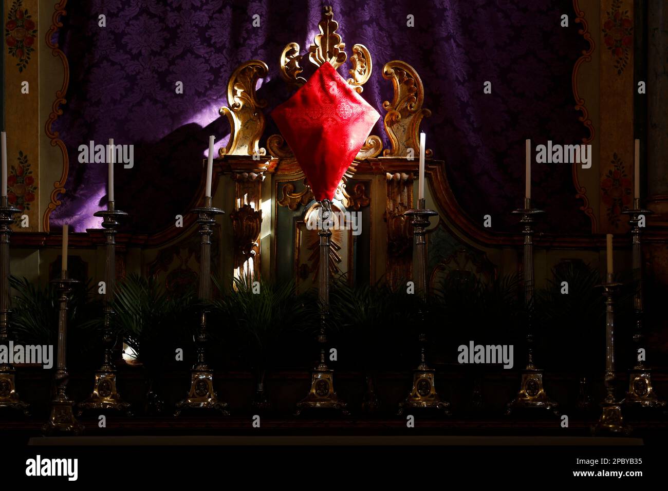 Holy Week. Cross covered with red fabric with dramatic and spot ...