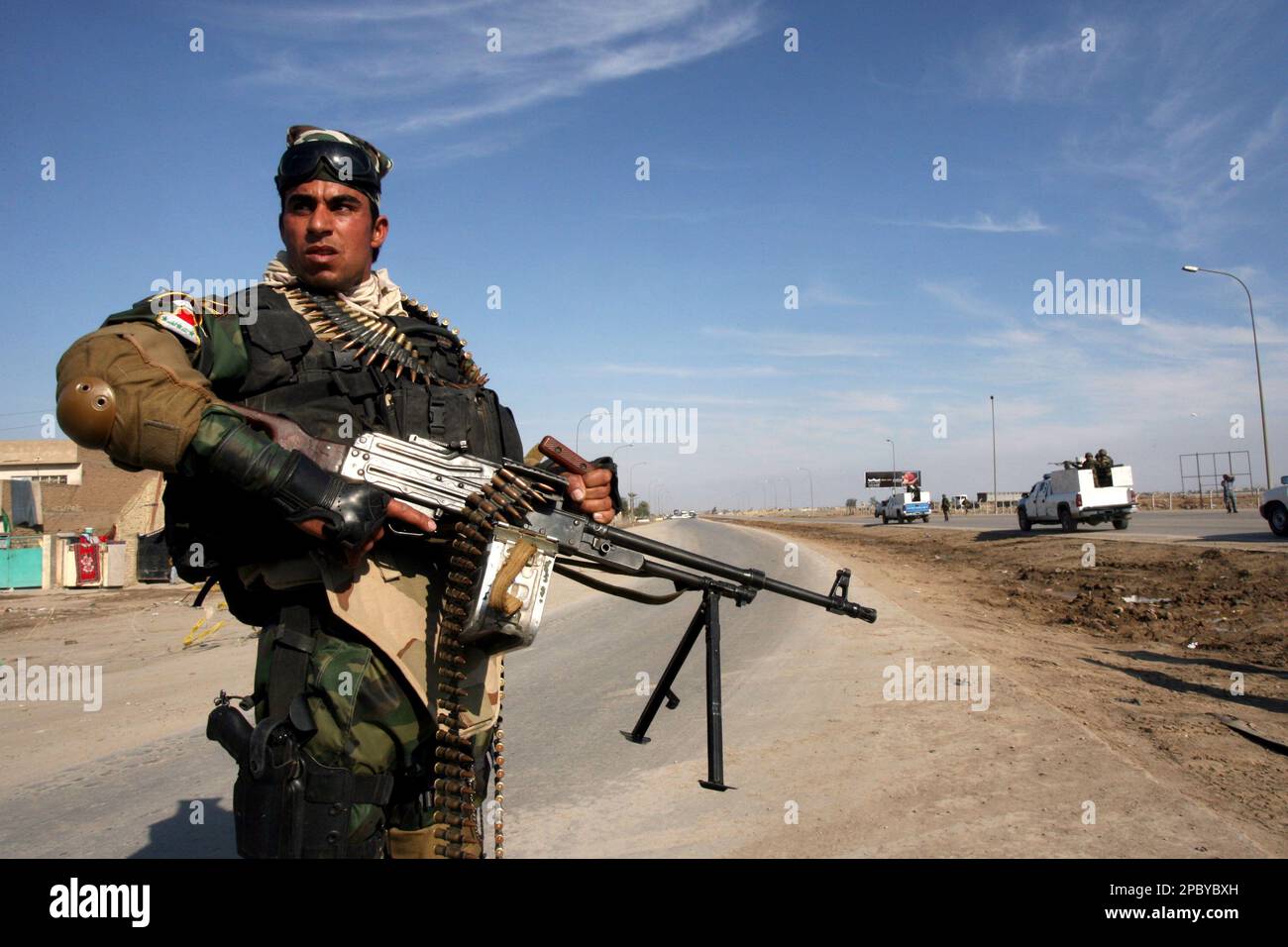 An Iraqi army soldier mans a machine gun while on patrol in Baghdad ...