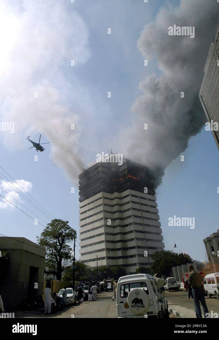 Smoke erupts from the 15-storey burning building of Pakistan National ...