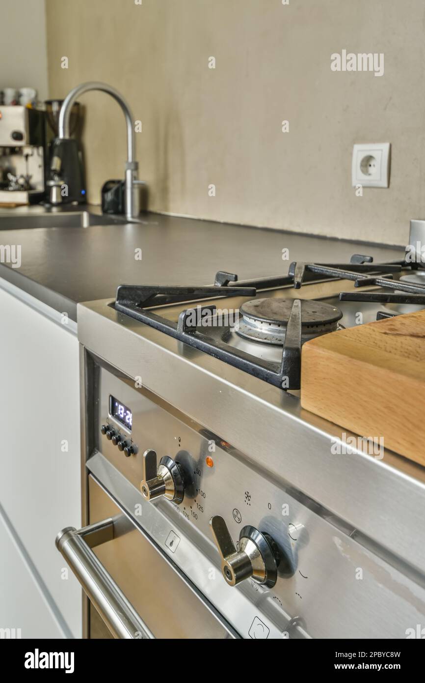 Contemporary kitchen interior with shiny steel gas stove and oven ...