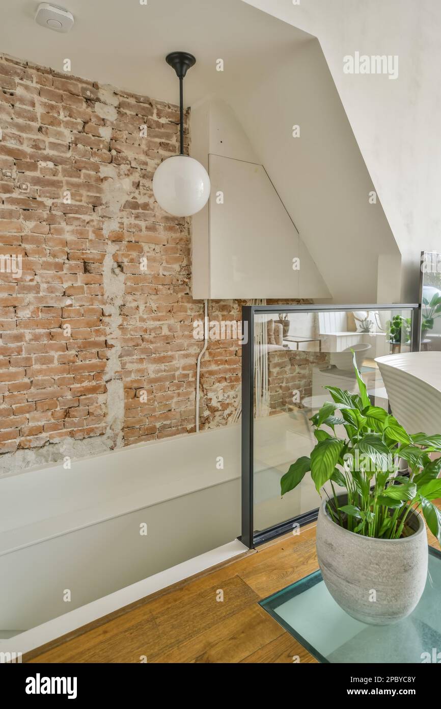 Interior design of contemporary room with brick wall and glass panel ...