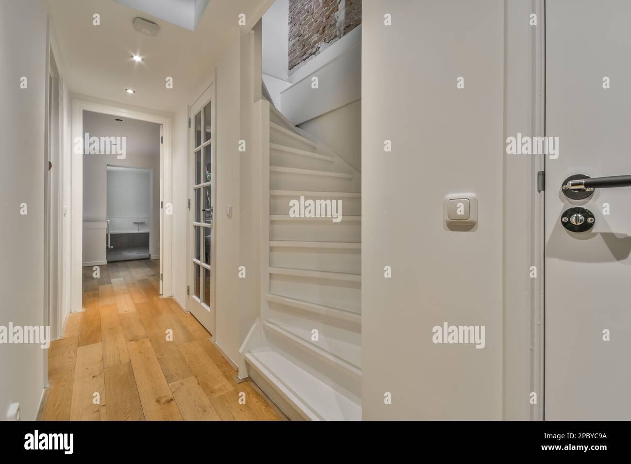Interior design of modern hallway with white walls and wooden floor in ...
