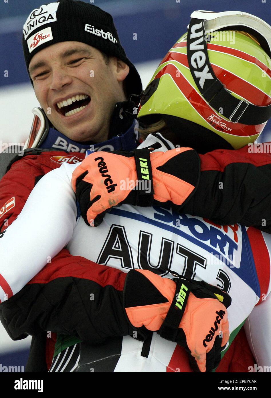 Austria's Benjamin Raich, front to camera, hugs compatriot Marlies ...
