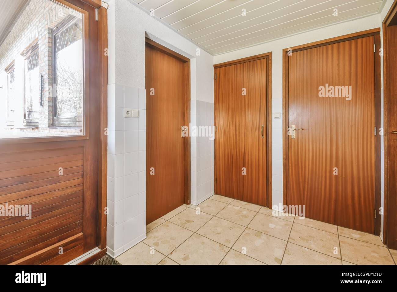 Minimalistic interior design of spacious corridor with white walls and ...