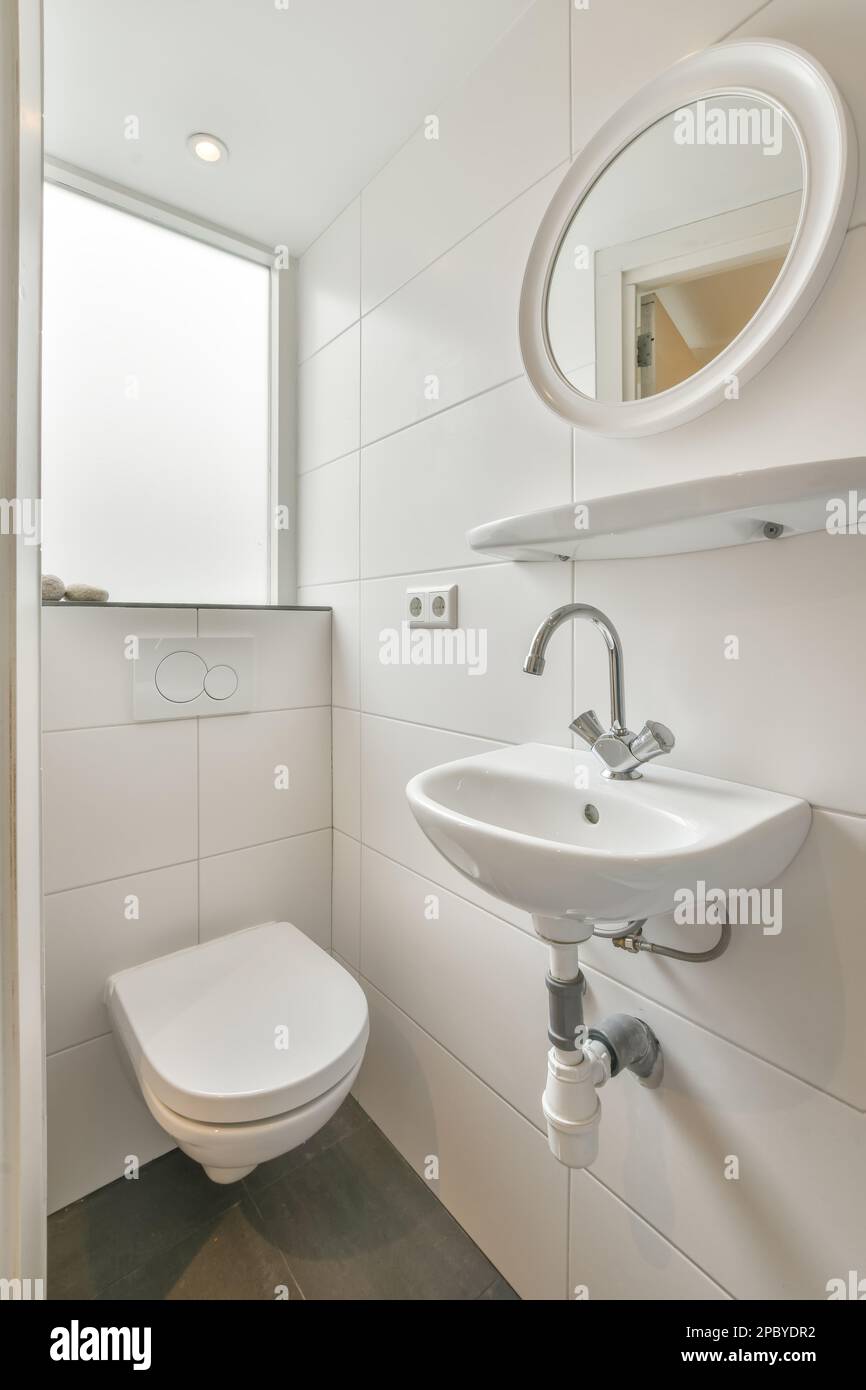 Interior of modern restroom design with white toilet bowl hanging on ...