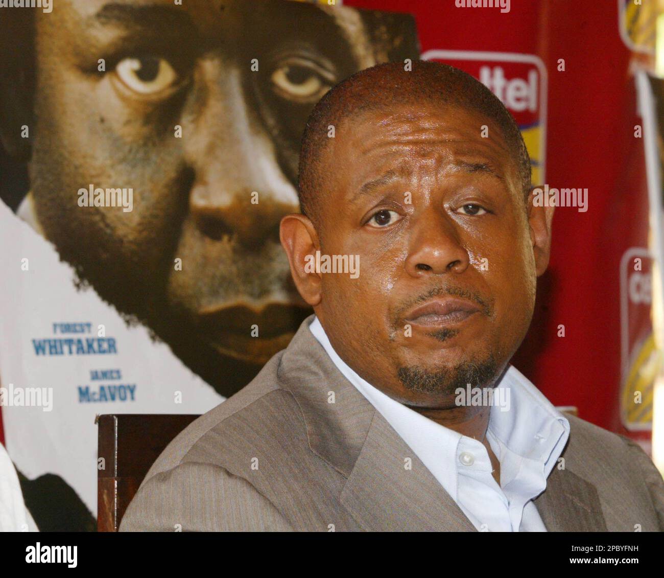 Forest Whitaker poses in front of a large banner of the film The Last ...