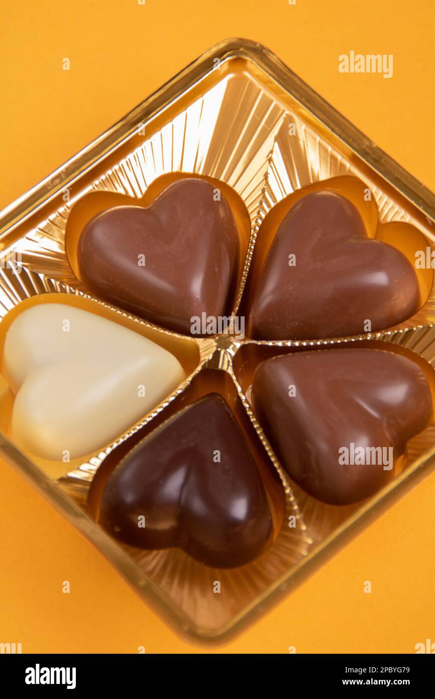 Photo package of different flavors of chocolate large on a yellow ...
