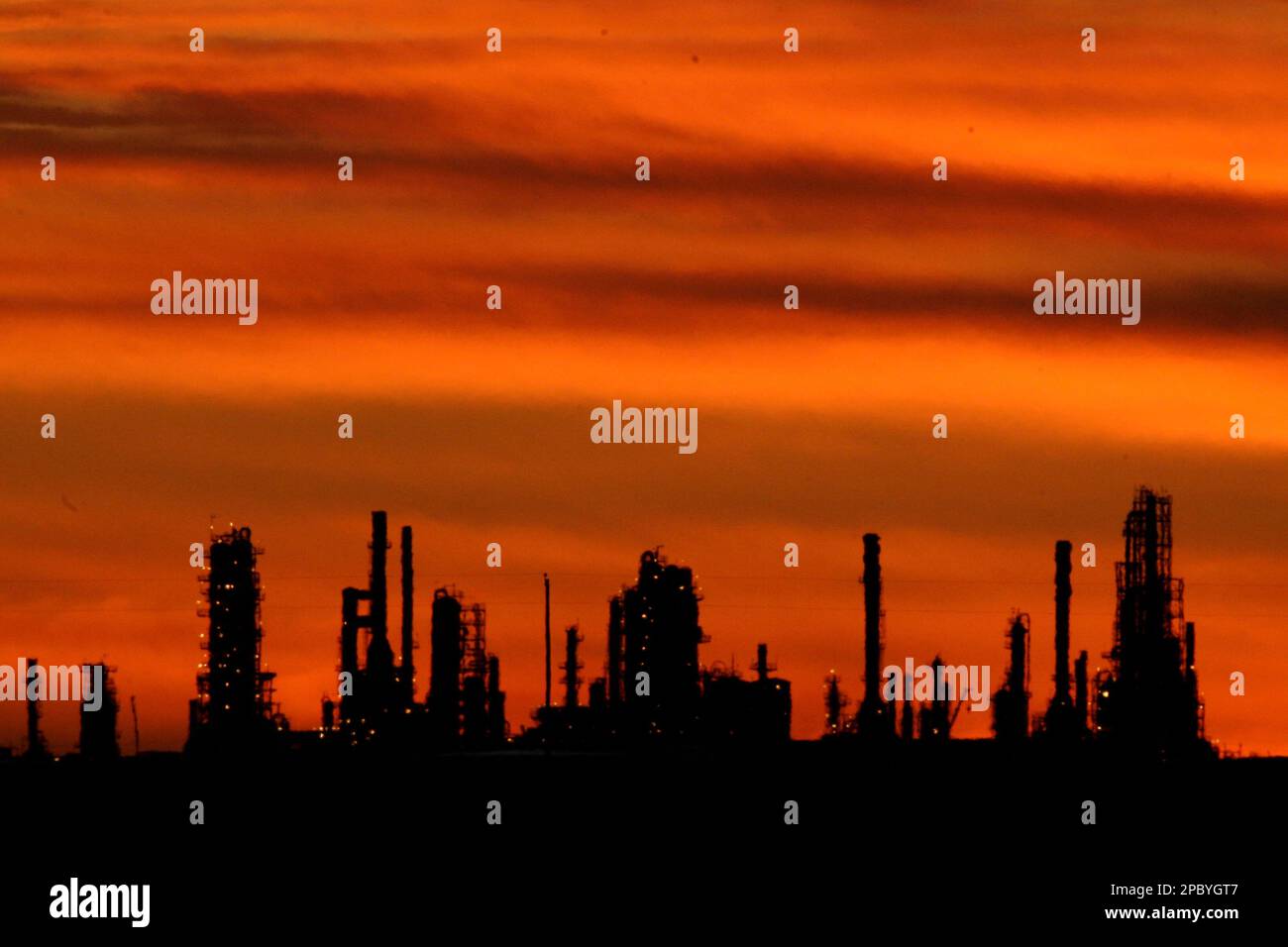 The sun rises behind the Valero McKee Refinery, where a small fire ...