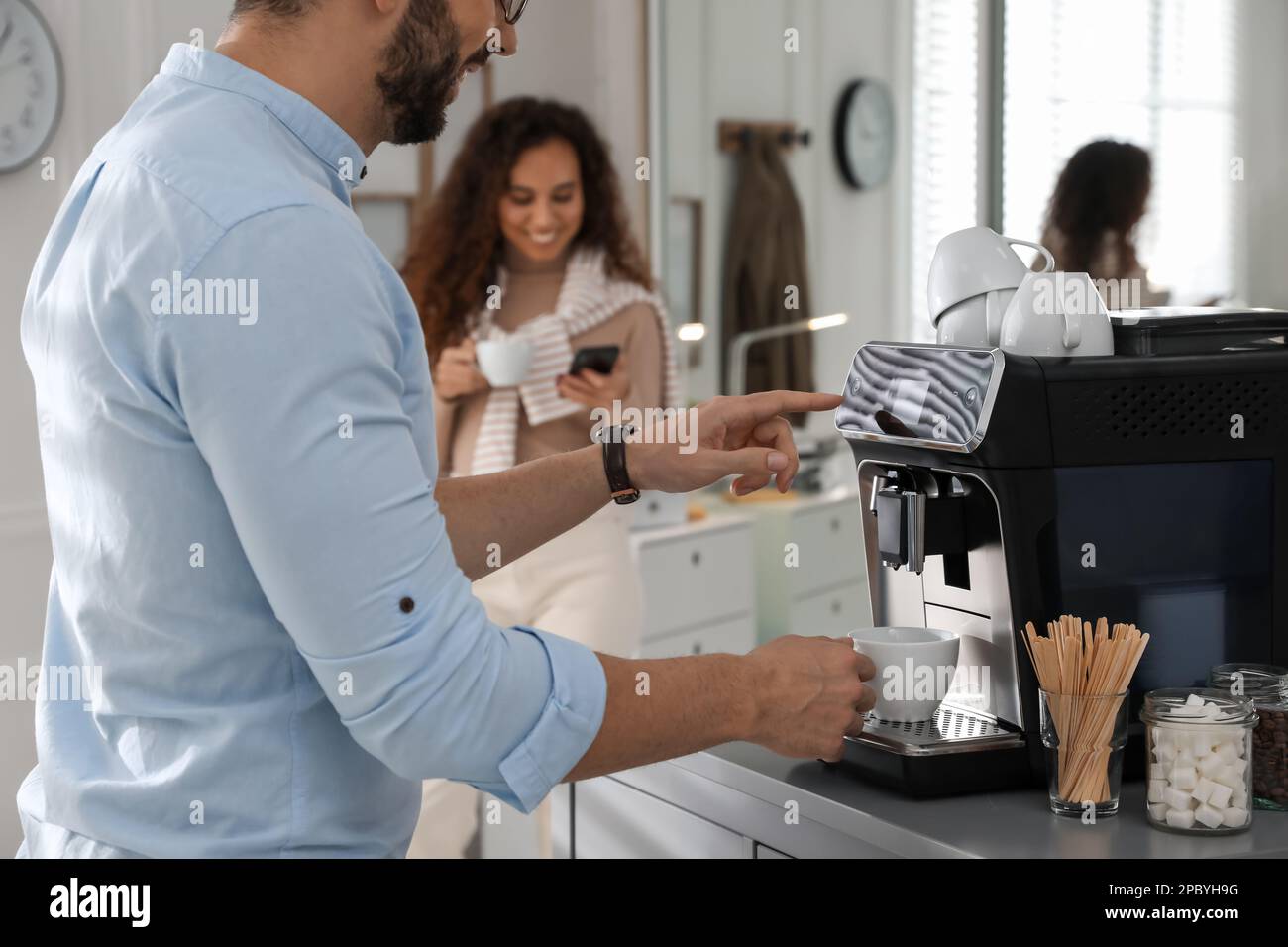 Man woman office coffee machine hi-res stock photography and images - Alamy