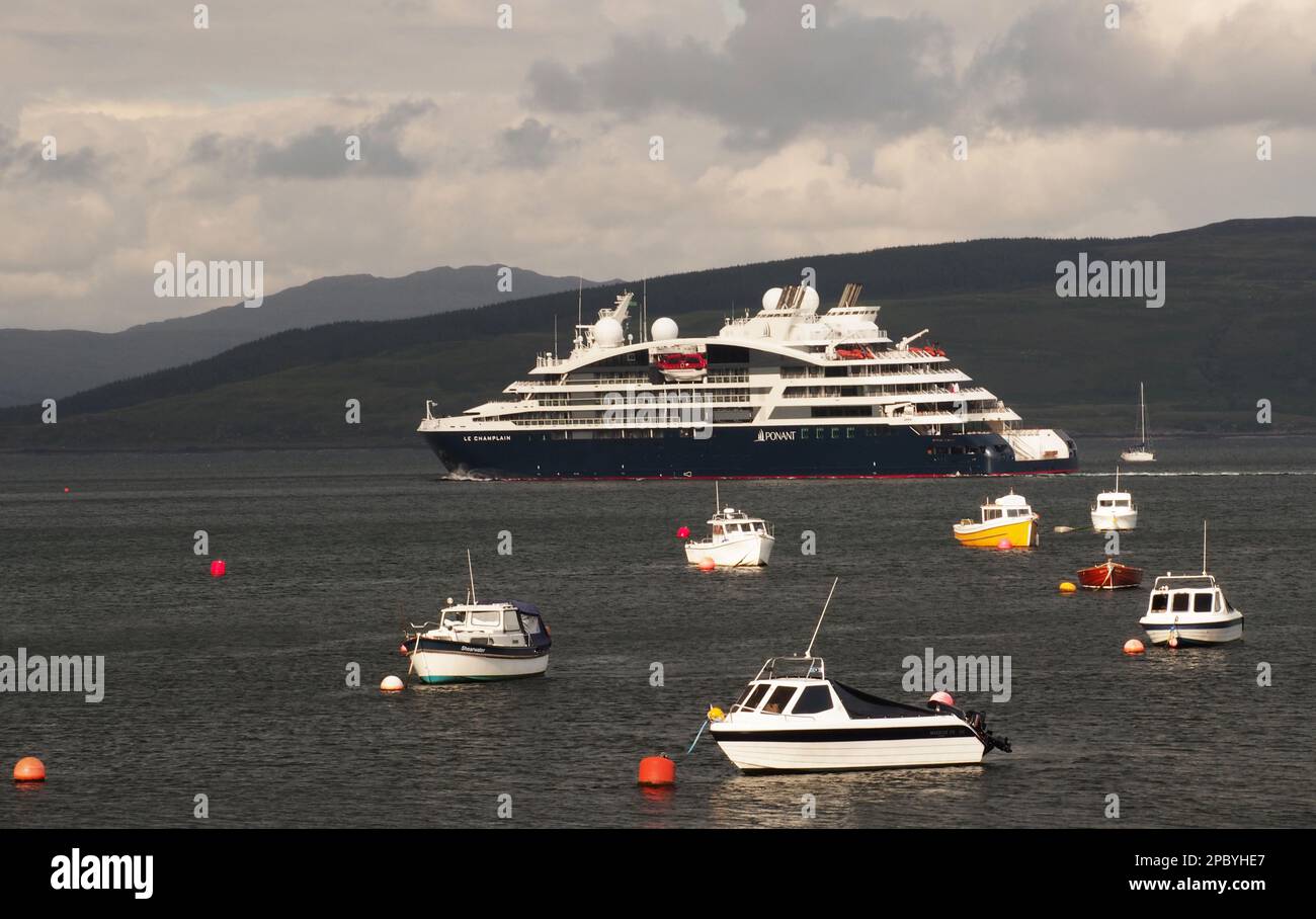 A Ponant cruise ship departing the natural seaport at Tobermory, on a ...