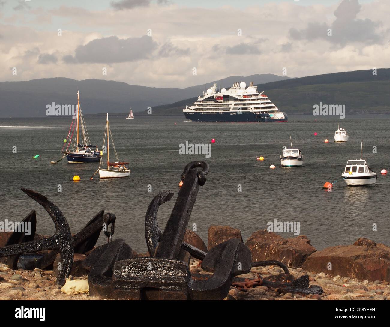 A Ponant cruise ship departing the natural seaport at Tobermory, on a ...
