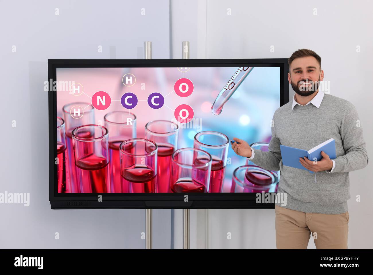 Teacher using interactive board in classroom during lesson Stock Photo ...