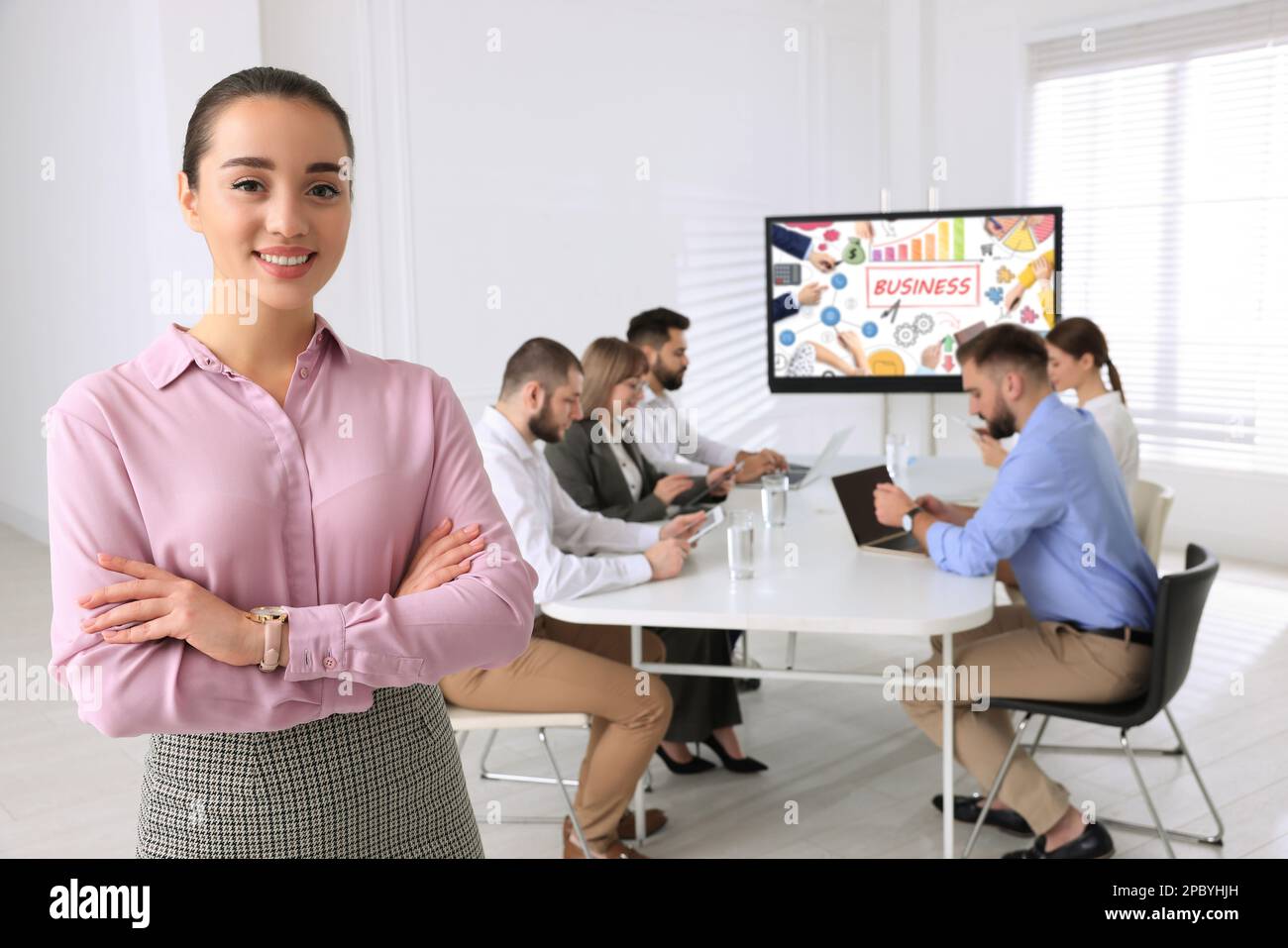 Business trainer in meeting room with interactive board during ...