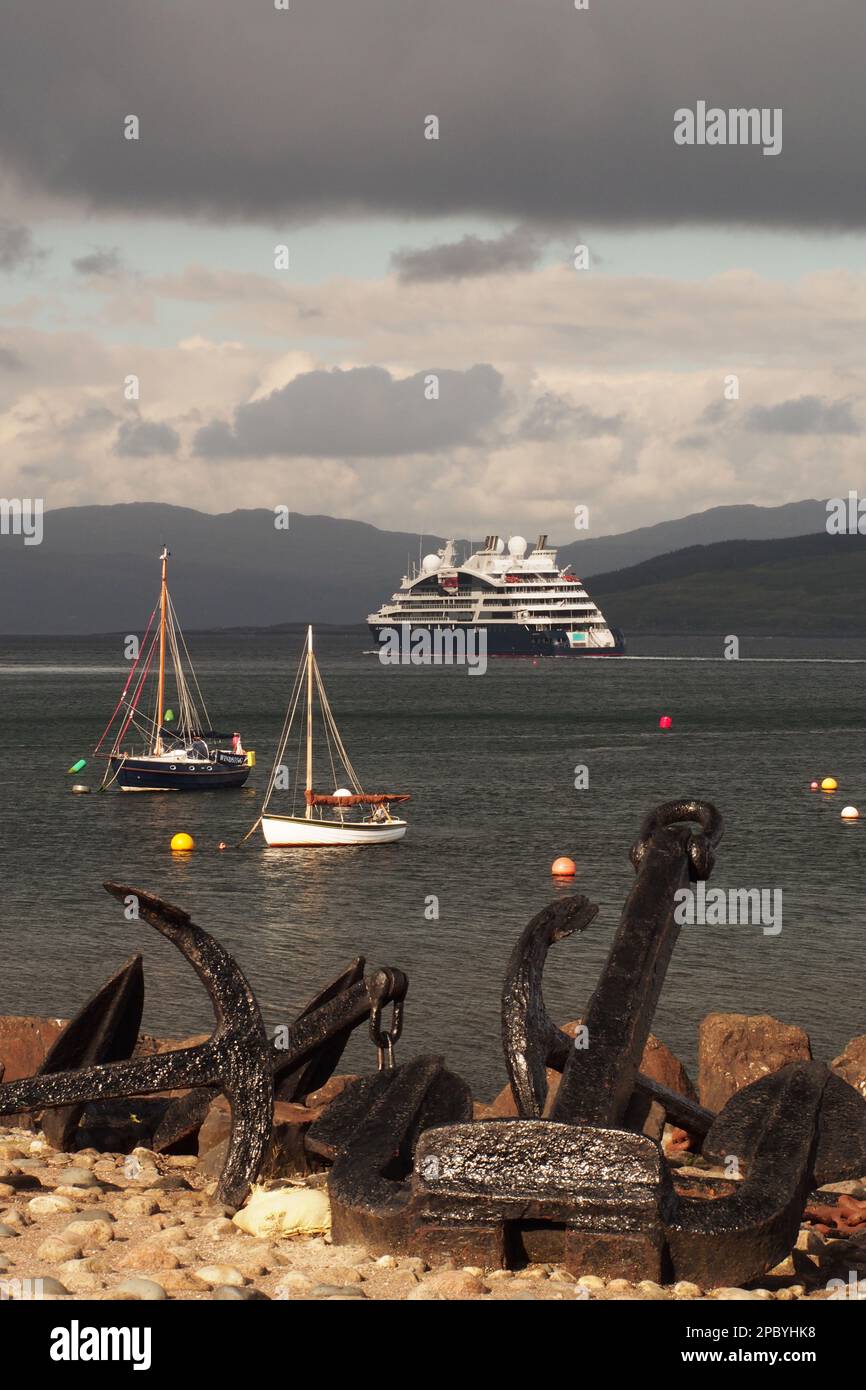 A Ponant cruise ship departing the natural seaport at Tobermory, on a ...
