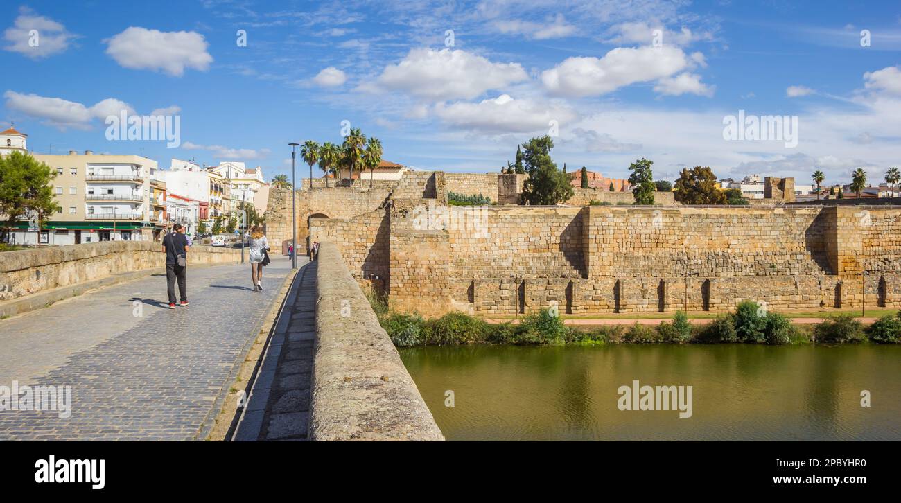 Panorama of people walking the roman bridge in Merida, Spain Stock ...