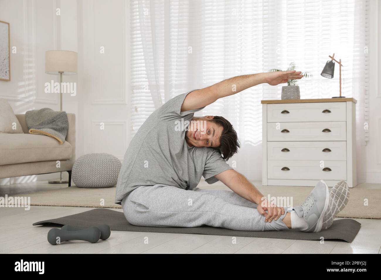 Obese man doing yoga on mat hi-res stock photography and images - Alamy