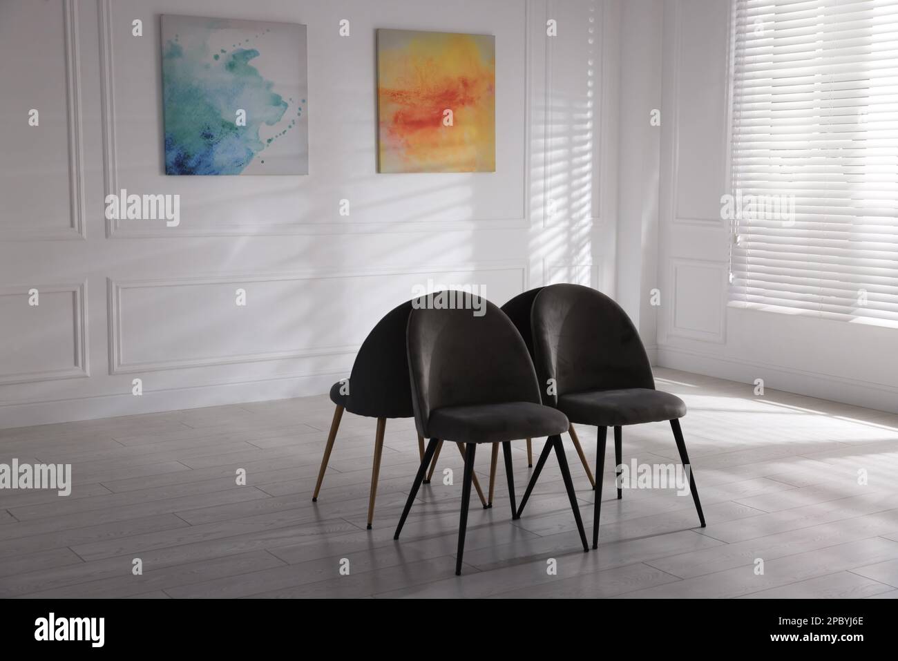 Chairs and beautiful paintings in art gallery Stock Photo - Alamy