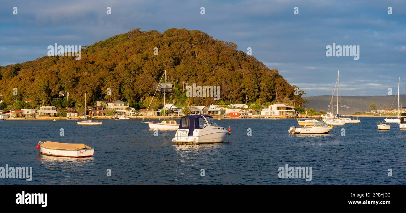 Boats tied up at their moorings in the warm early morning sunlight at ...