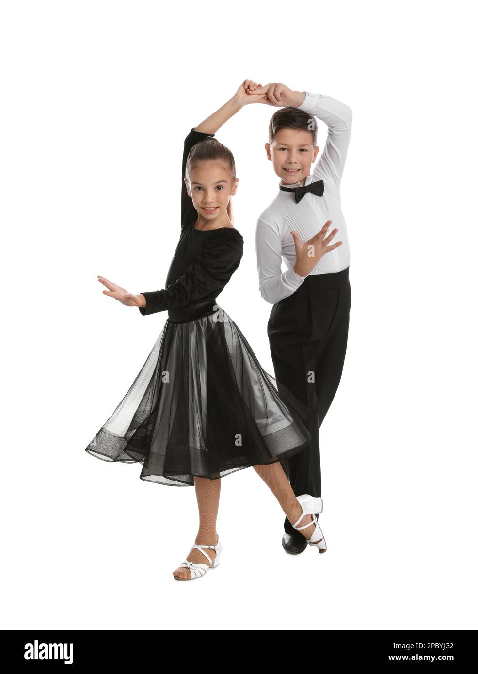 Beautifully dressed couple of kids dancing on white background Stock ...