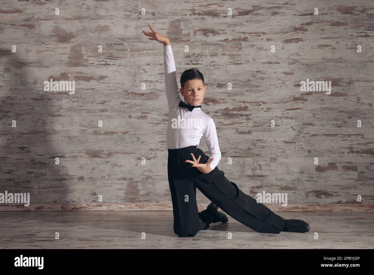Beautifully dressed little boy dancing in studio Stock Photo - Alamy