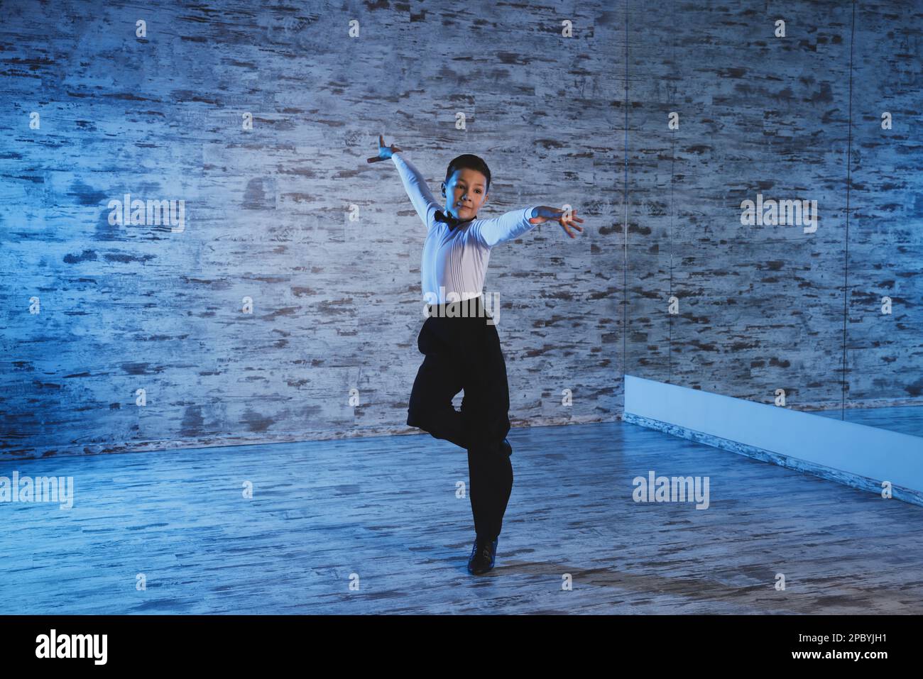 Beautifully dressed little boy dancing in studio Stock Photo - Alamy