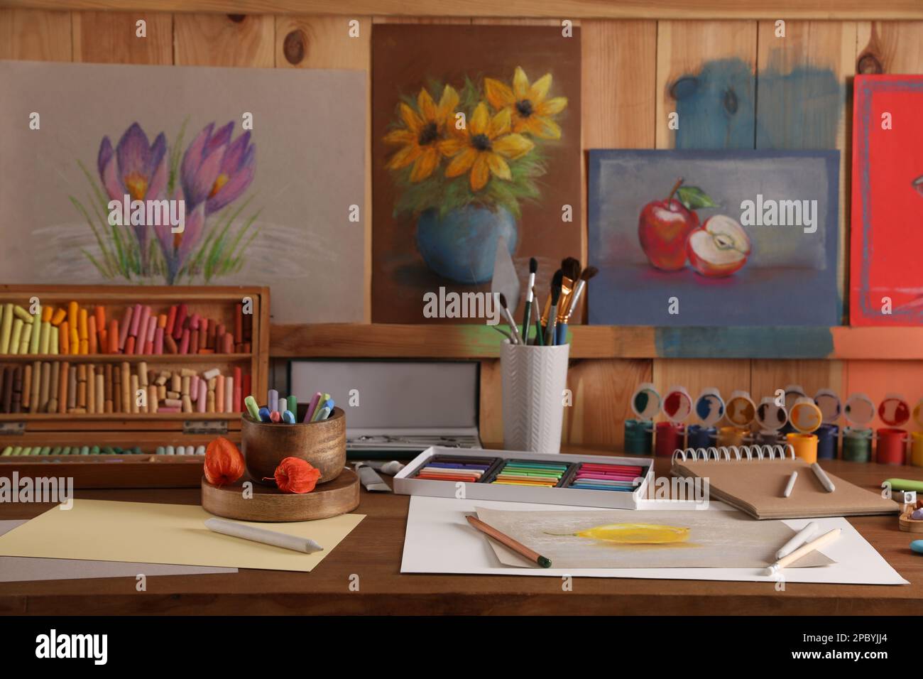 Artist's workplace with drawing, soft pastels and color pencils on ...