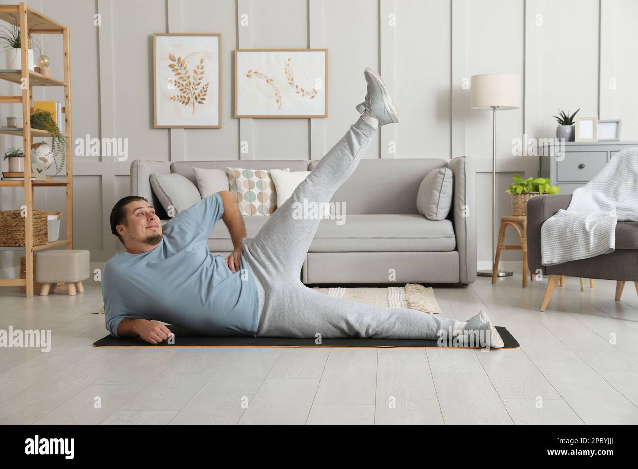 Obese man doing yoga on mat hi-res stock photography and images - Alamy